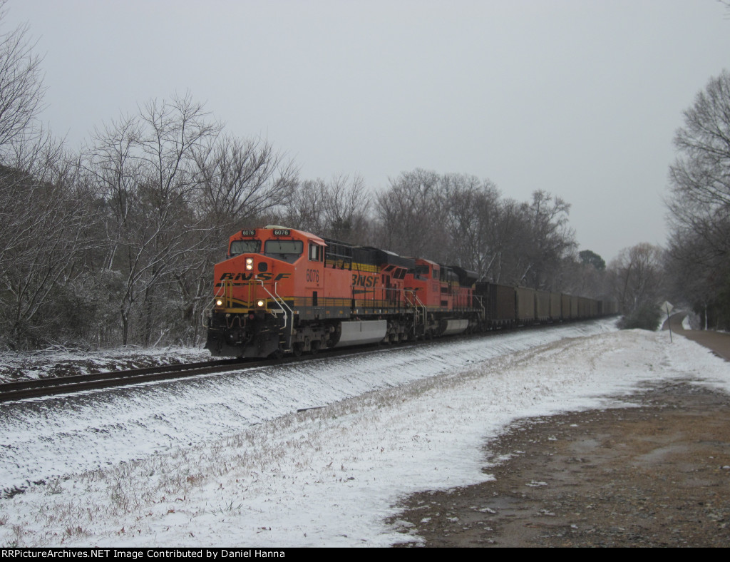 BNSF 6076 leads 737 west on a snowy afternoon